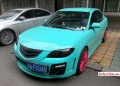 Mazda 3 sedan is Turquoise with Pink alloys in China